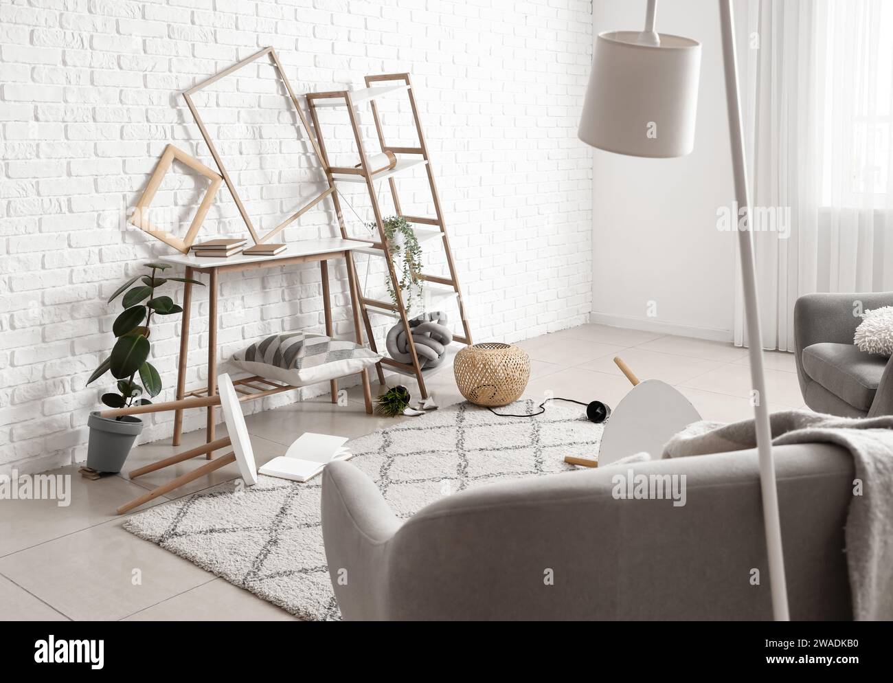 Tables with shelving unit in messy living room Stock Photo - Alamy