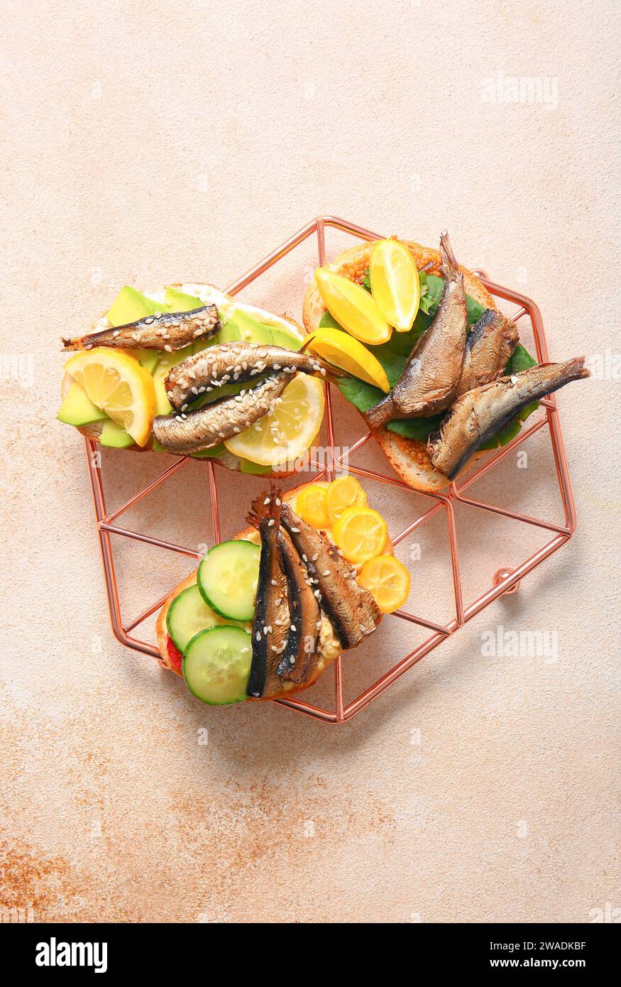 Grid of tasty sandwiches with canned smoked sprats on white background ...
