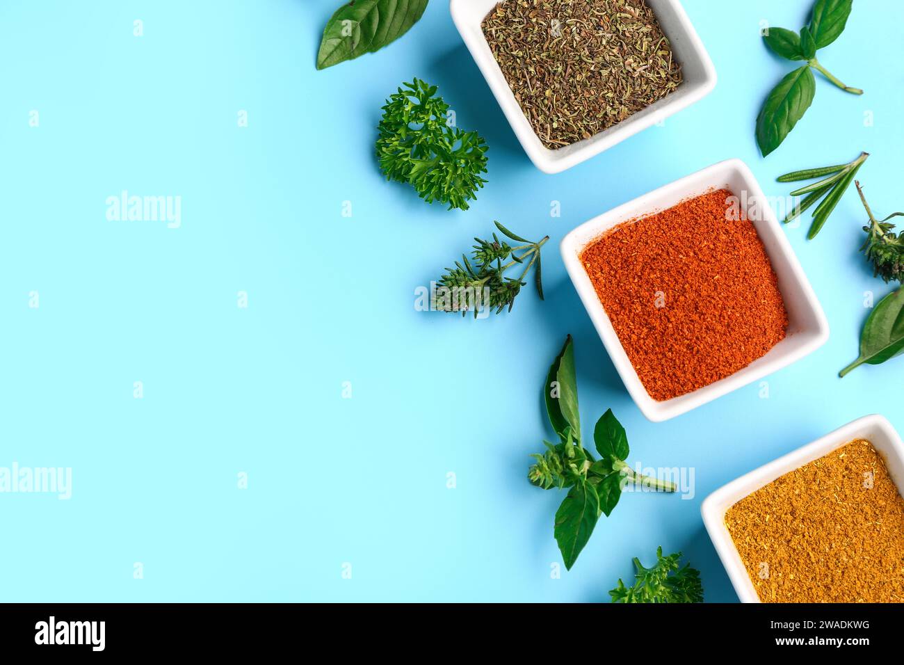 Composition with bowls of aromatic spices and herbs on color background ...