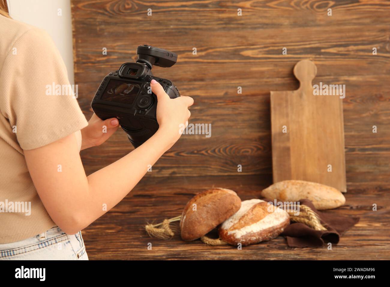 Female photographer taking photo of fresh bread in studio Stock Photo ...