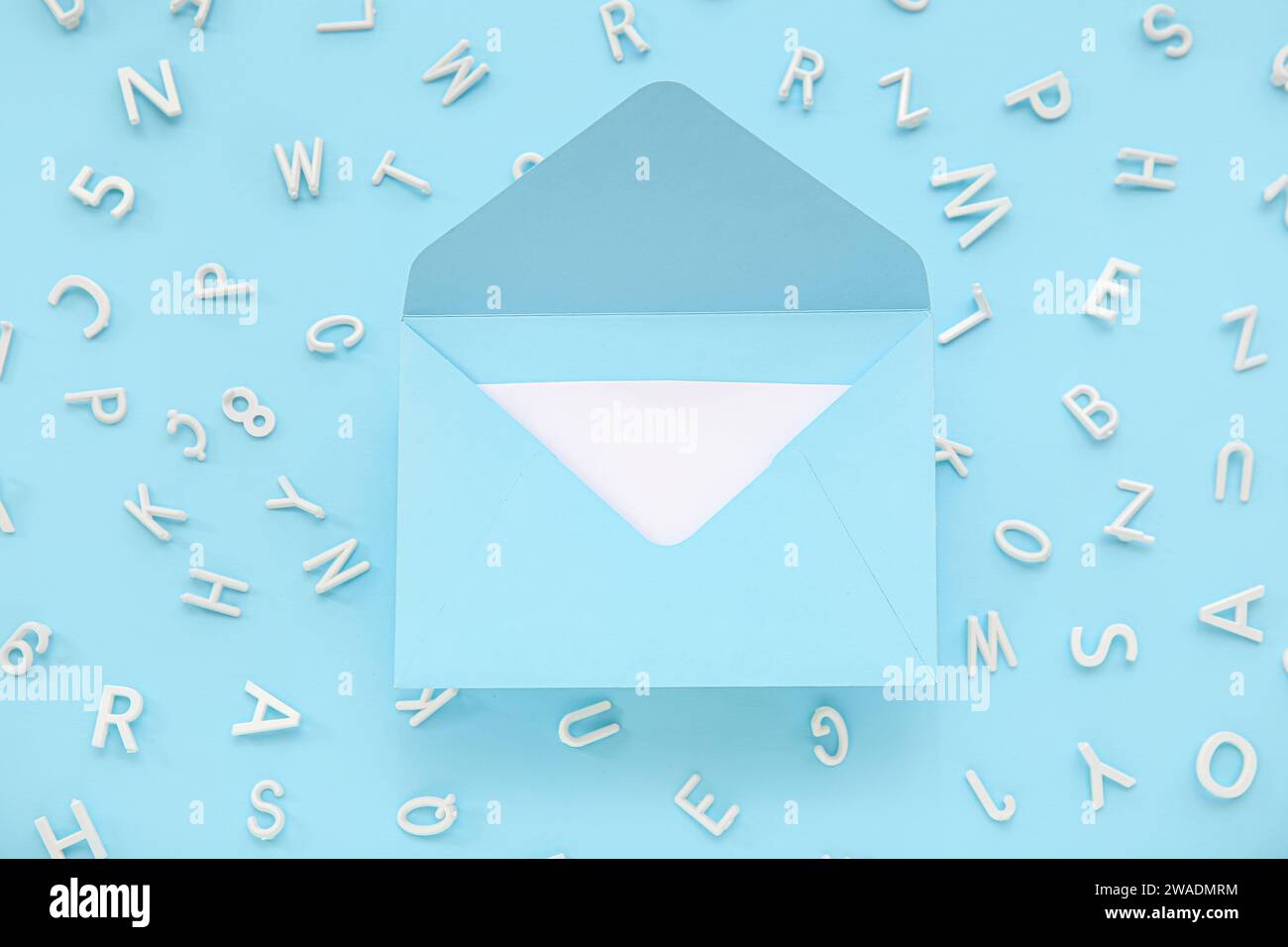 Open envelope with scattered letters on blue background Stock Photo - Alamy