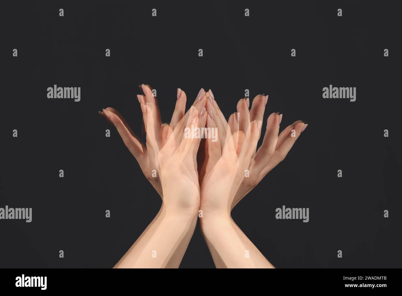 Stroboscopic photo of moving female hands on dark background Stock ...
