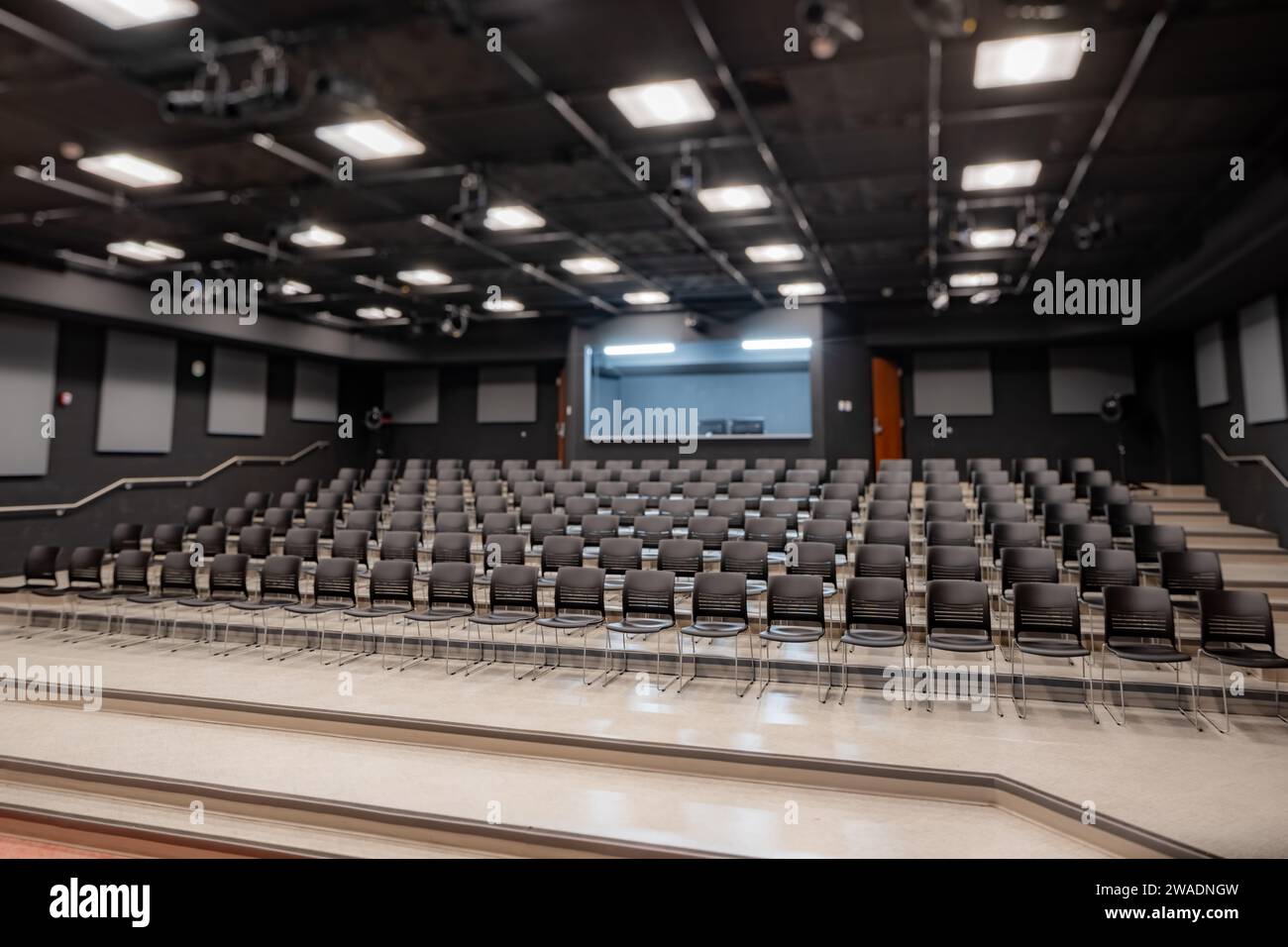Photo of a new school theater, auditorium, with gray seats, chairs ...