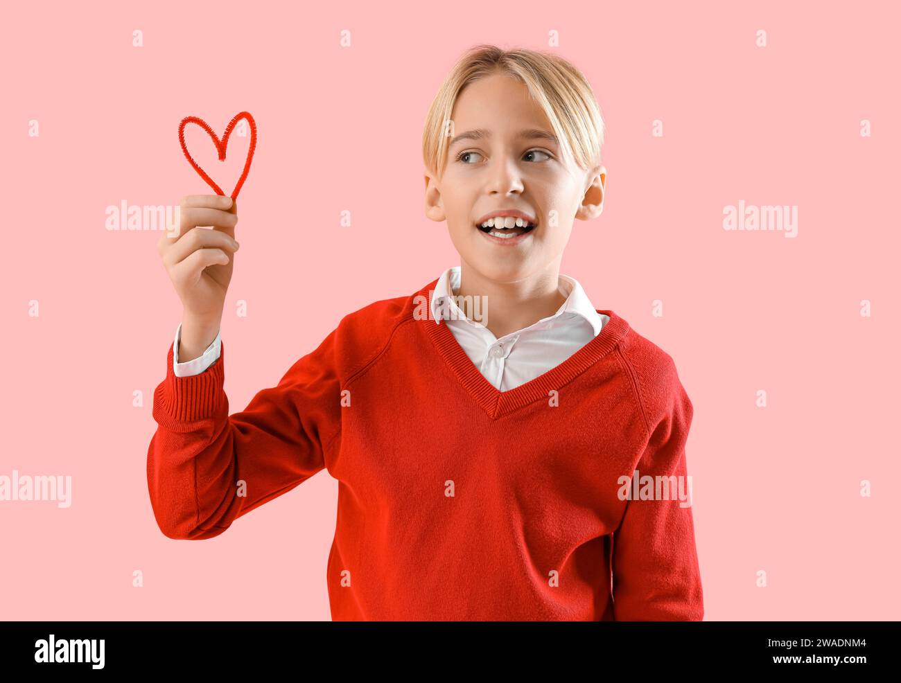 Cute little boy with red heart on pink background. Valentine's day ...