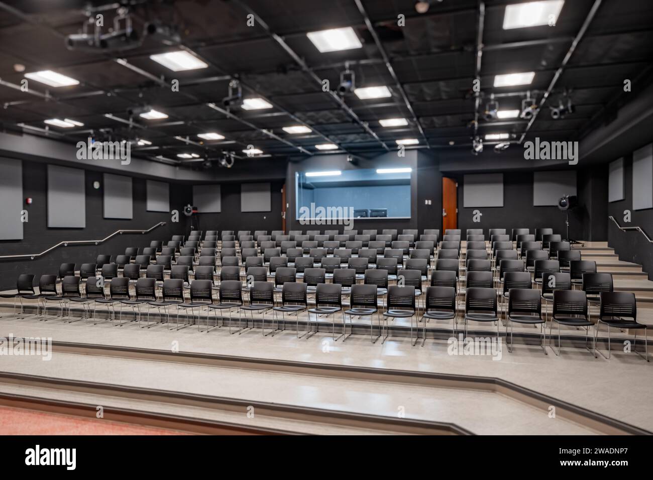 Photo of a new school theater, auditorium, with gray seats, chairs ...