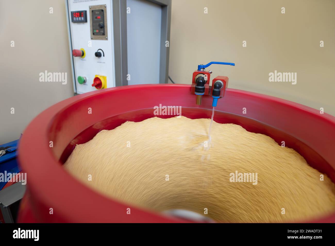 tumbling machine at work with coins Stock Photo - Alamy