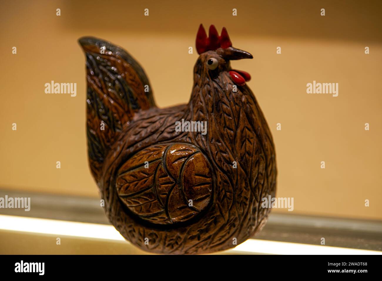 A cute wood carving of a fat rooster Stock Photo - Alamy