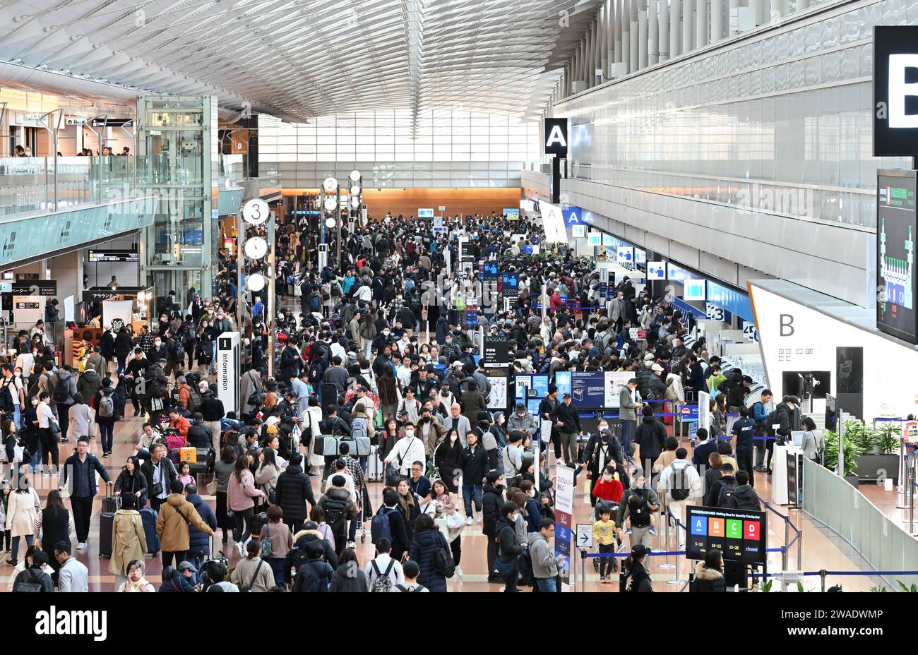Haneda Airport Terminal 2 departure lobby crowded with passengers after 120 ANA flights were ...