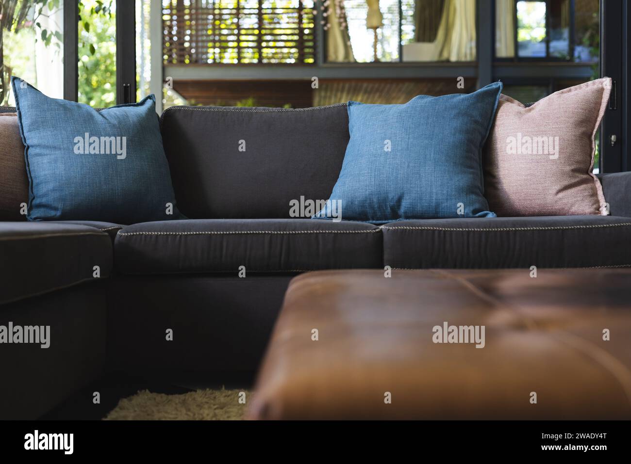 Modern big empty house with cosy terrace with couch in big green garden ...