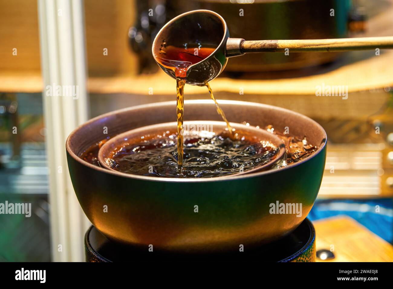 Traditional Chinese copper pot is cooking Pu'er tea, making tea around ...