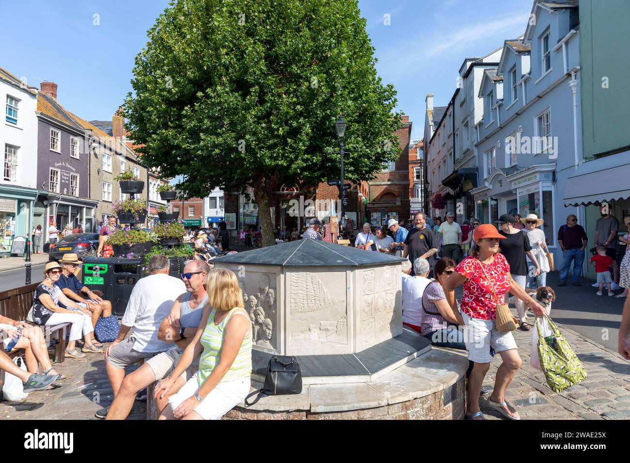 Bridport Dorset, sunny autumn day and locals rest in Bucky Doo Square ...