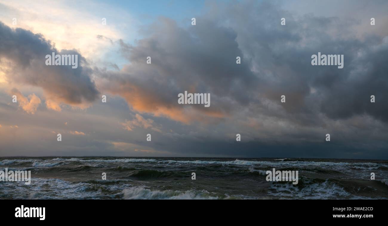 Dramatic clouds and sunlight during stormy weather over ocean hi-res ...