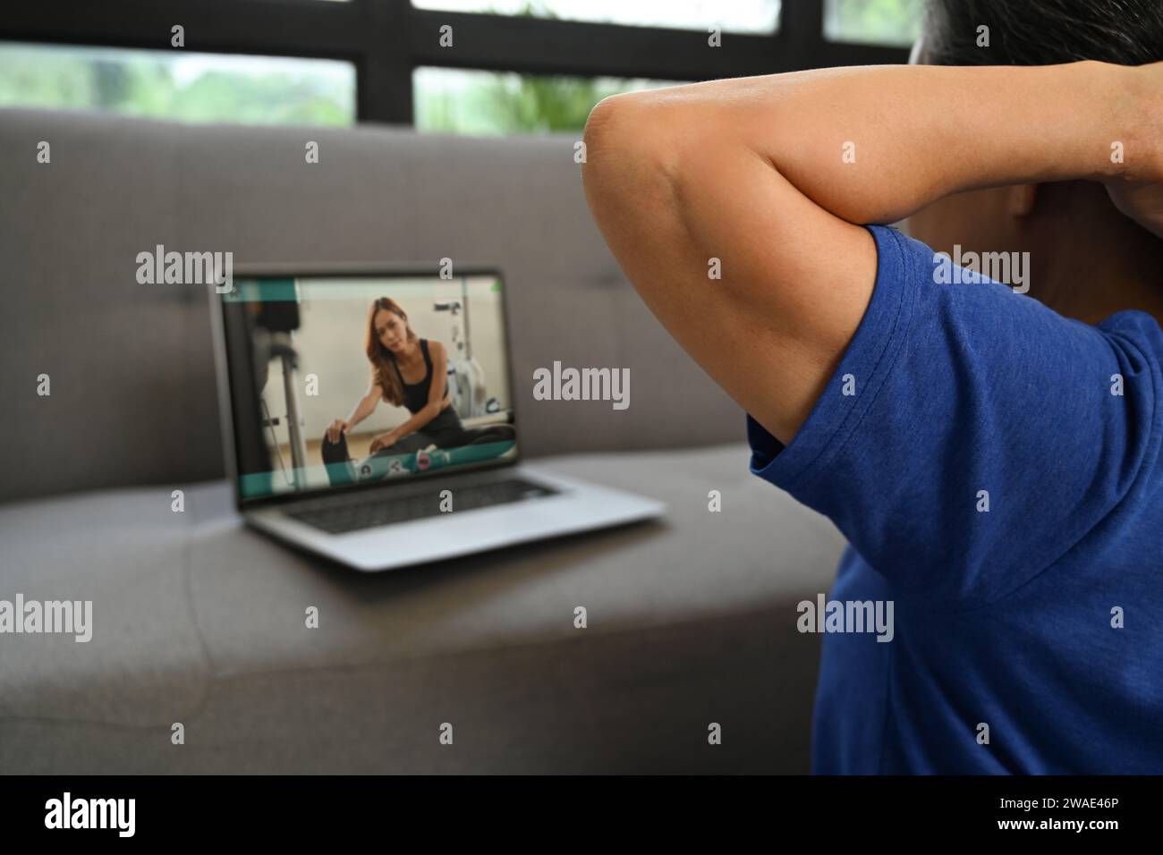 Active senior woman watching video training tutorial online and doing ...