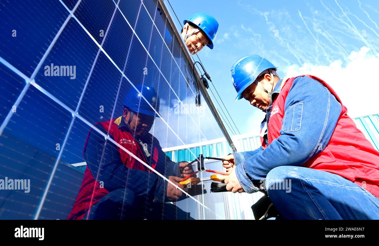 ZHANGYE, CHINA - JANUARY 4, 2024 - Power workers test and debug the ...