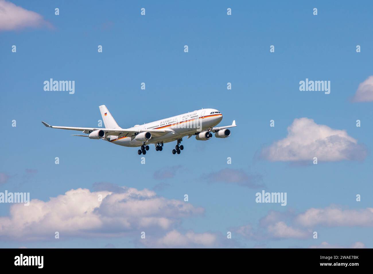 A German plane flying high above clouds in the blue sky Stock Photo - Alamy
