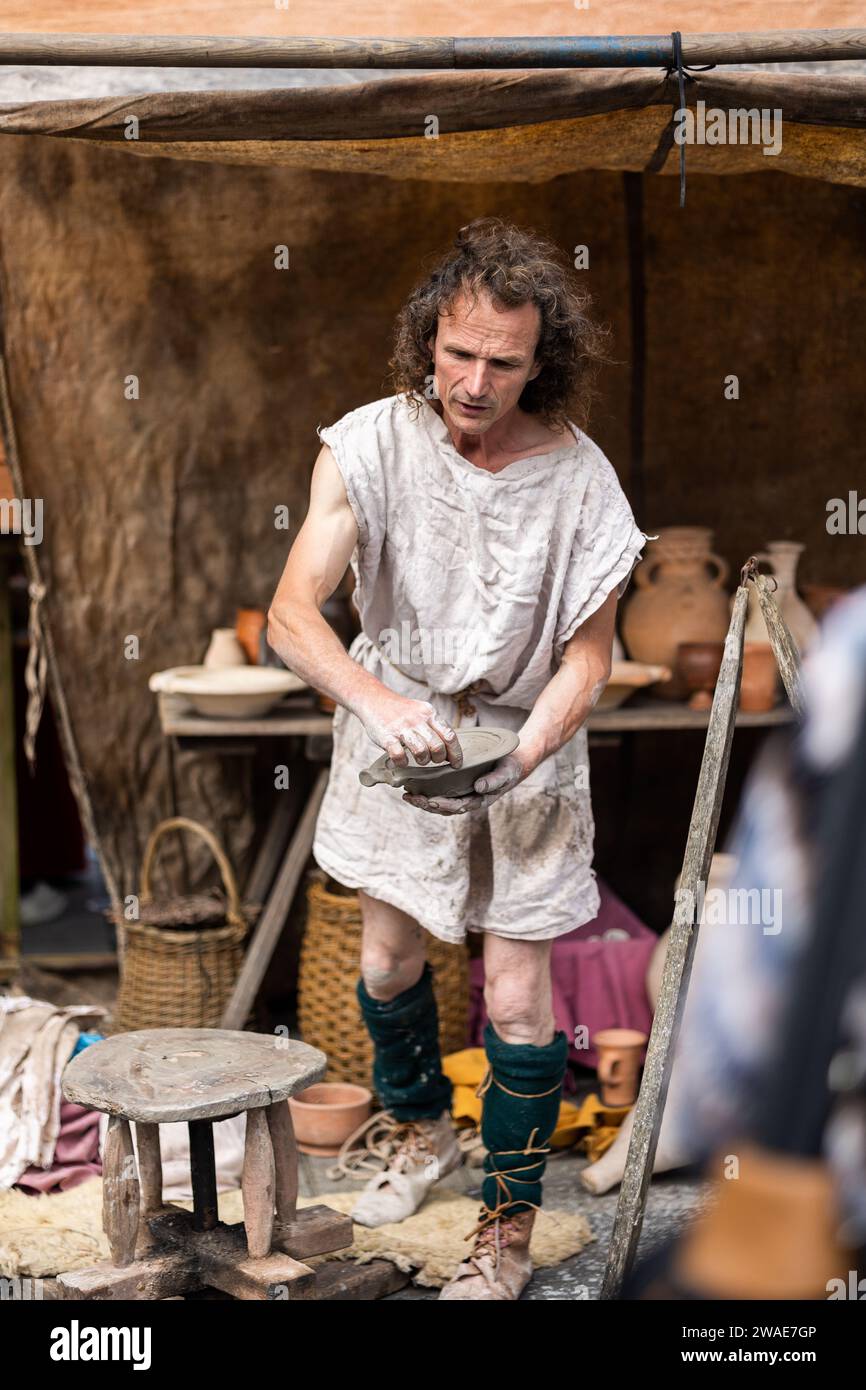 A Man dressed in roman attire talking about roman pottery Stock Photo ...