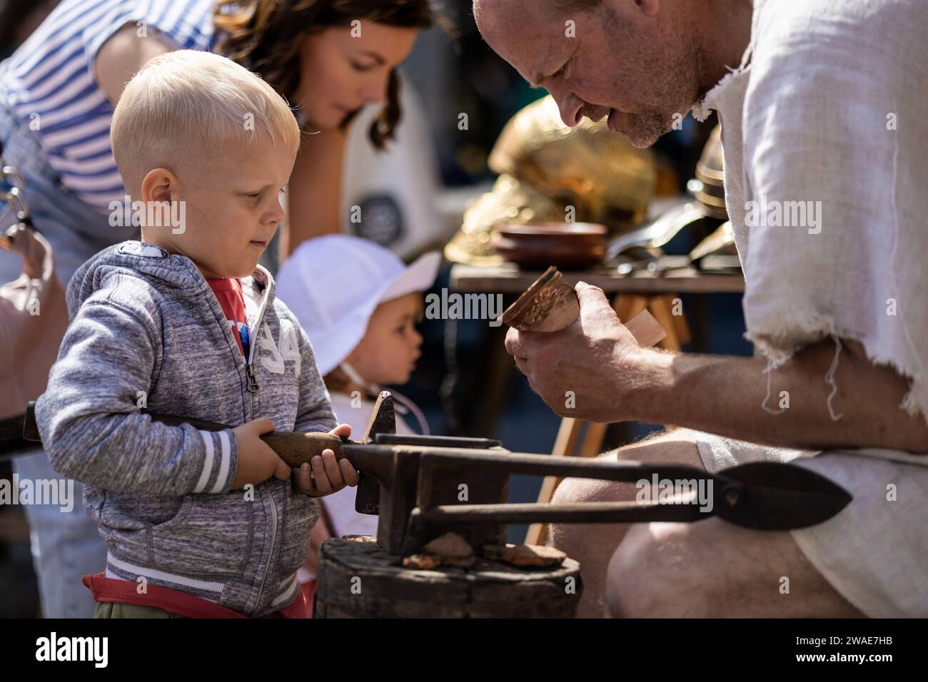 A Man dressed in roman attire talking about roman tools and equipments ...