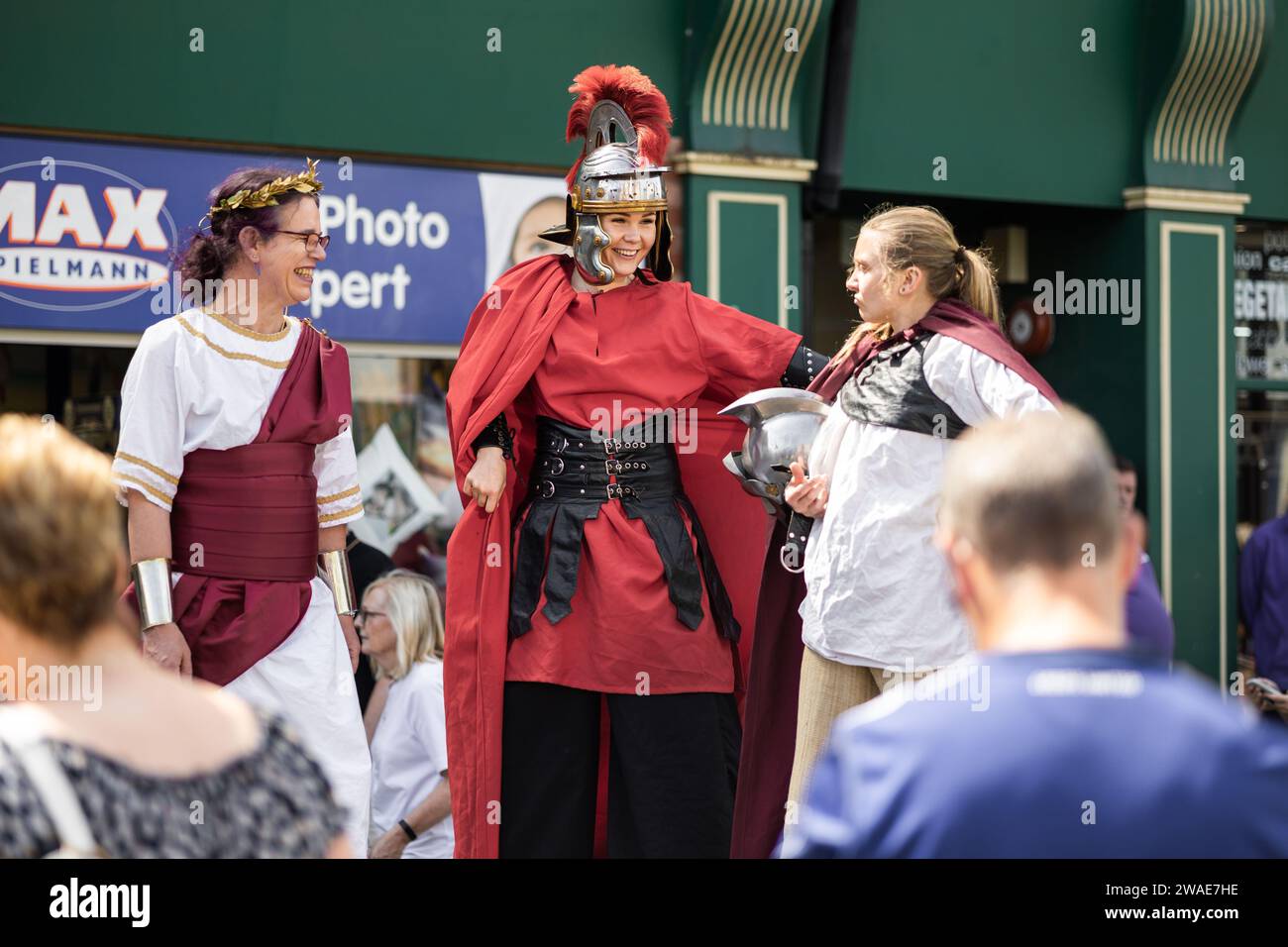 A picture of three women wearing Roman attires during a Roman festival ...