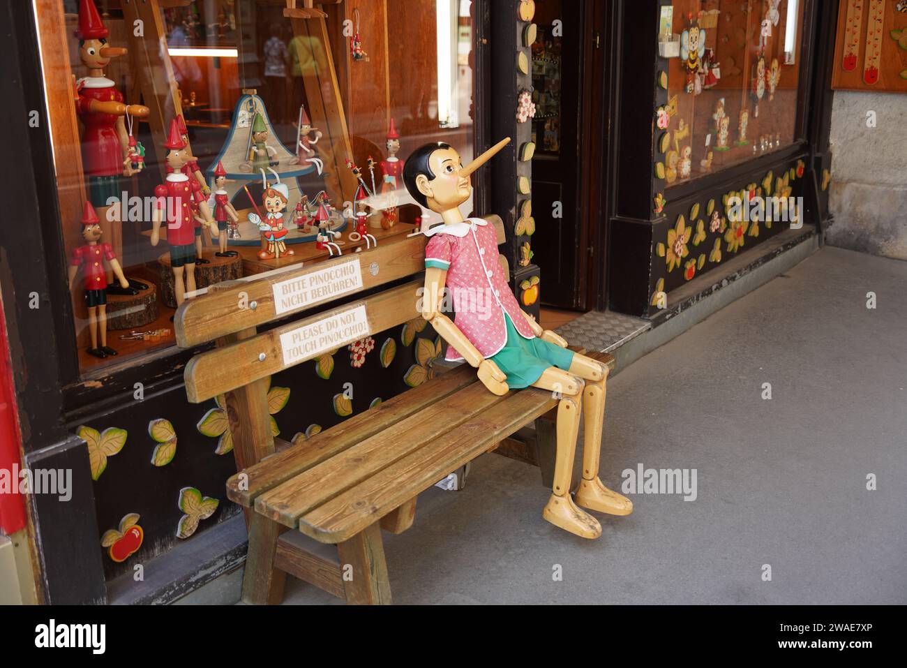 Pinocchio sitting on wooden bench hi-res stock photography and images ...