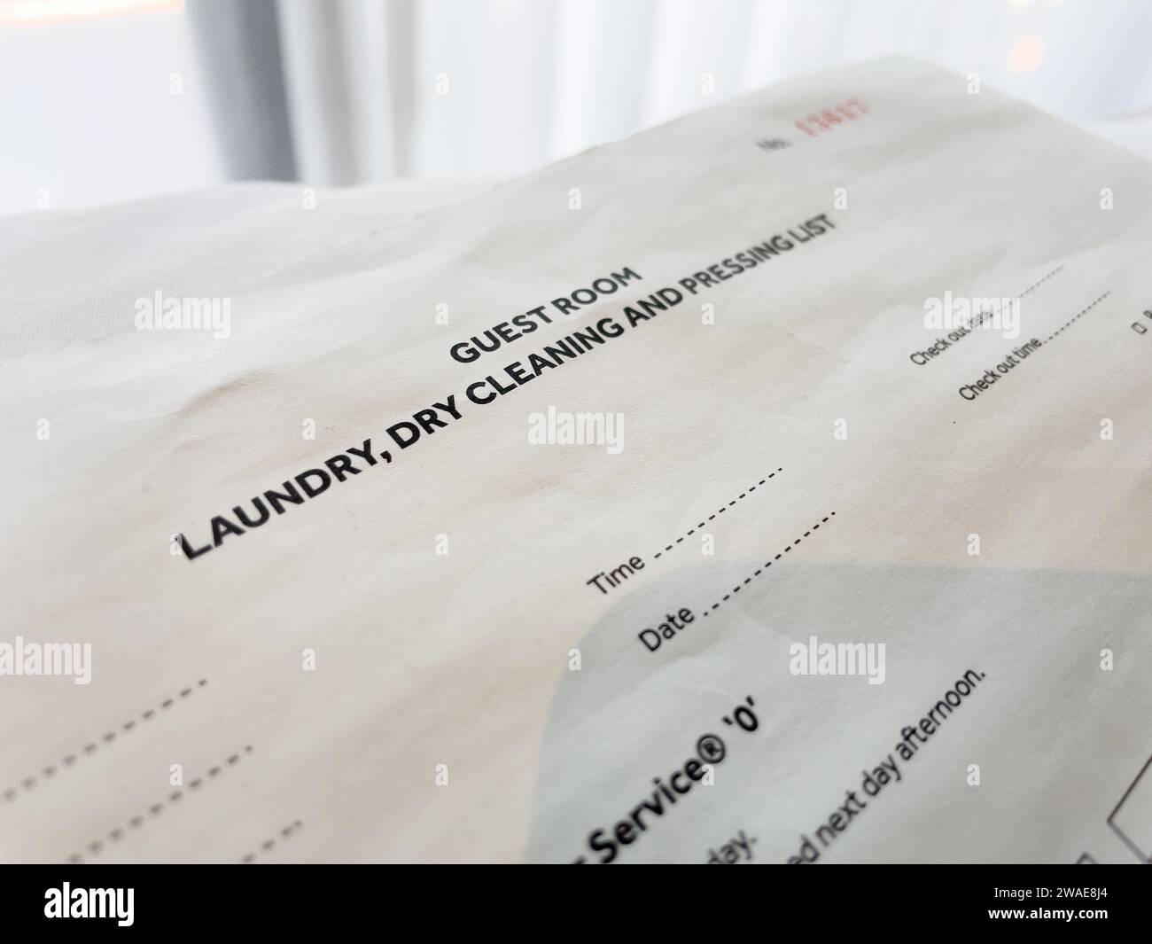 Laundry room service form at a hotel room Stock Photo - Alamy