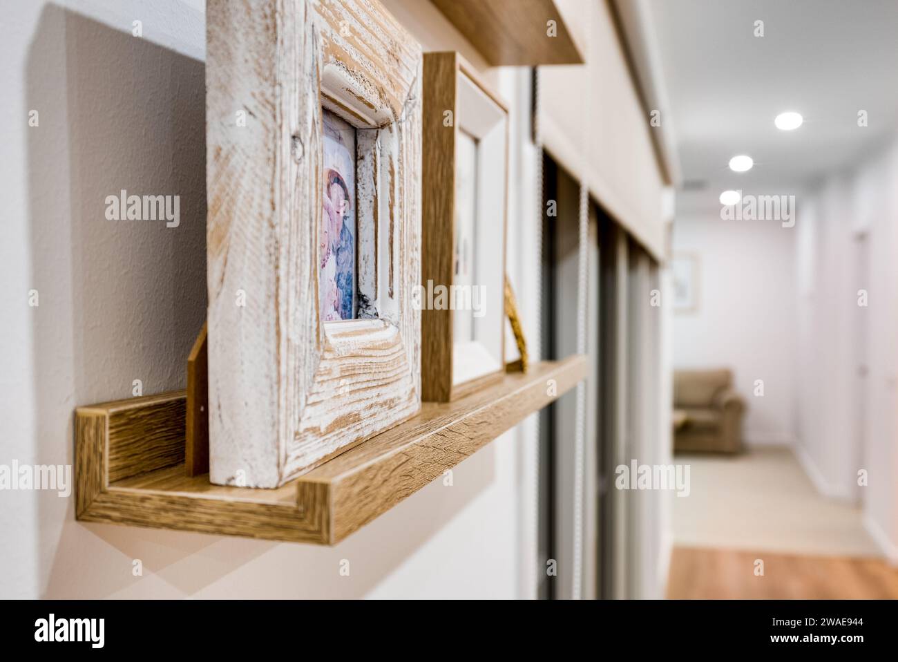 A shallow side view of wooden photo frames in a nicely furnished house ...
