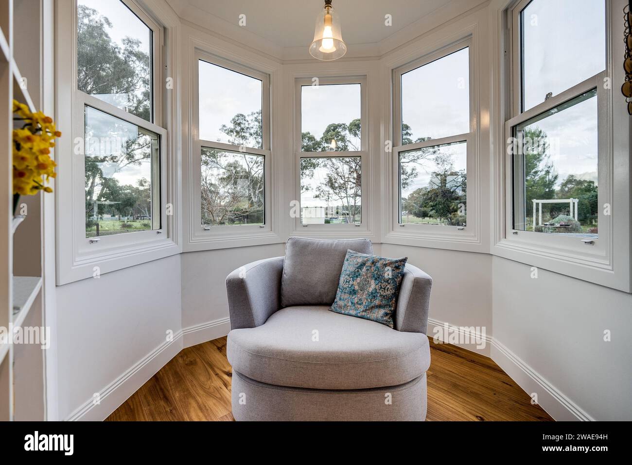 An armchair surrounded by windows Stock Photo - Alamy