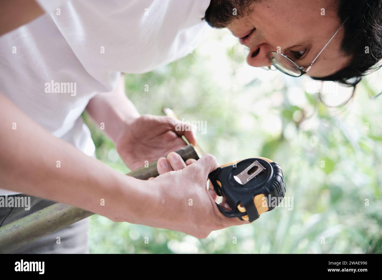 Young man taking measurements hi-res stock photography and images - Alamy