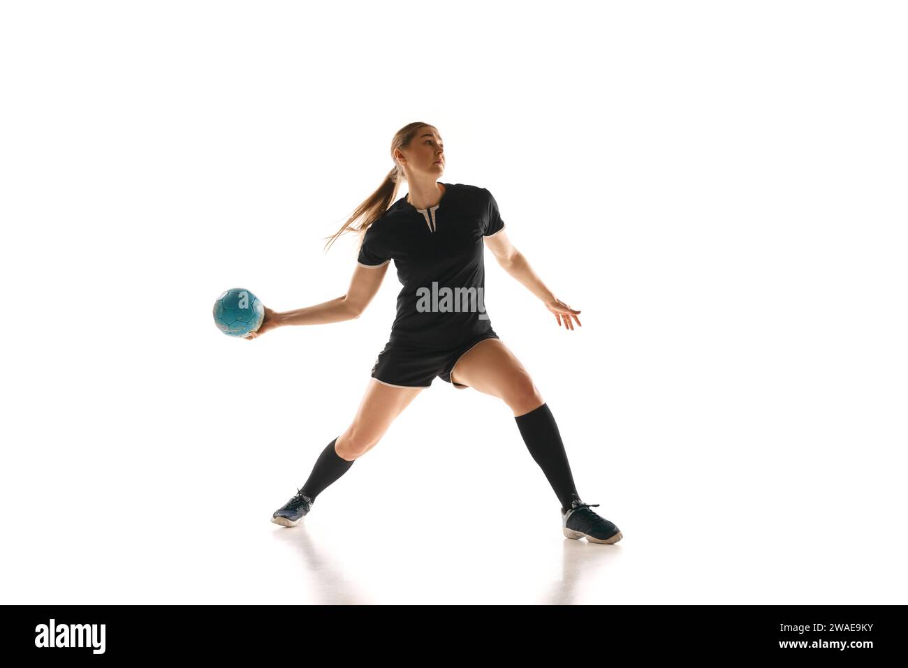 Concentrated female handball player perfecting her throw, highlighting ...