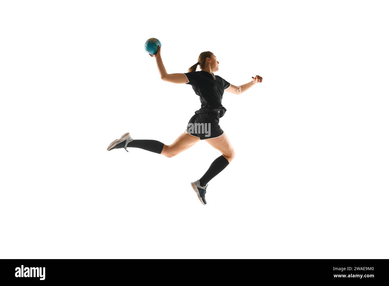 Female handball enthusiast executing precise throw, emphasizing the ...