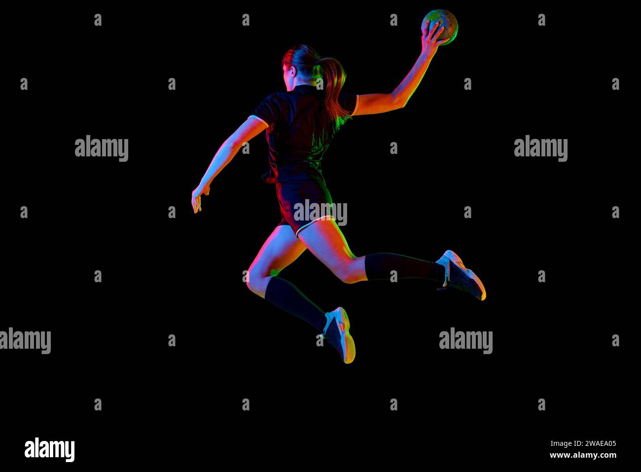 Fit young woman engaged in intense handball training, perfecting her ...