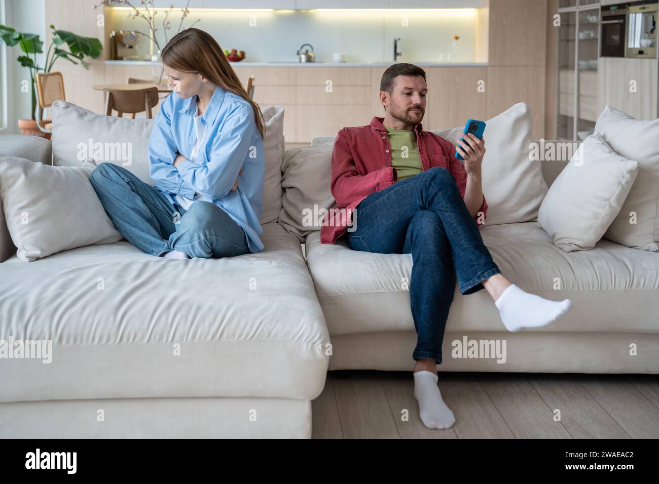 Sad woman reaction offendedly turned away from pleased husband looking ...