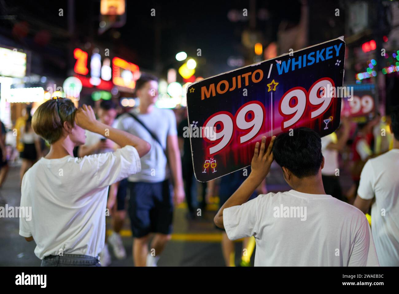 PHUKET, THAILAND - APRIL 25, 2023: man with ad poster on Patong Beach ...