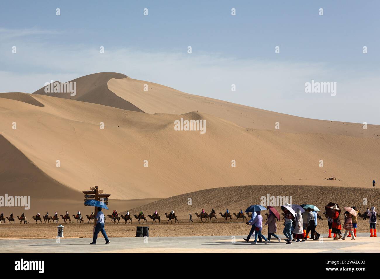 A diverse group of people heading to the Singing dunes and the Crescent ...