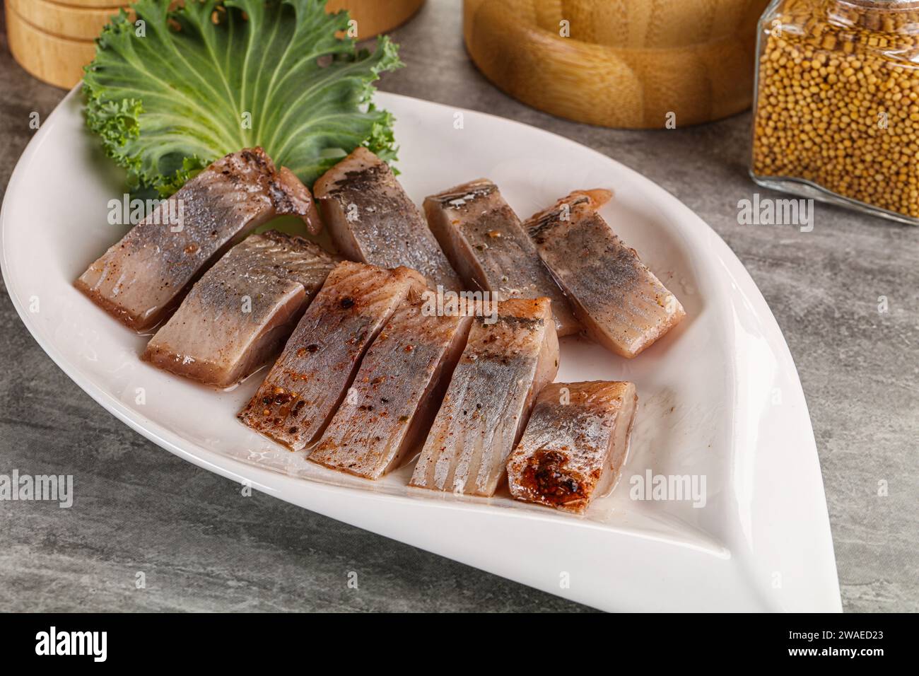 Sliced spicy salted herring fillet snack Stock Photo - Alamy