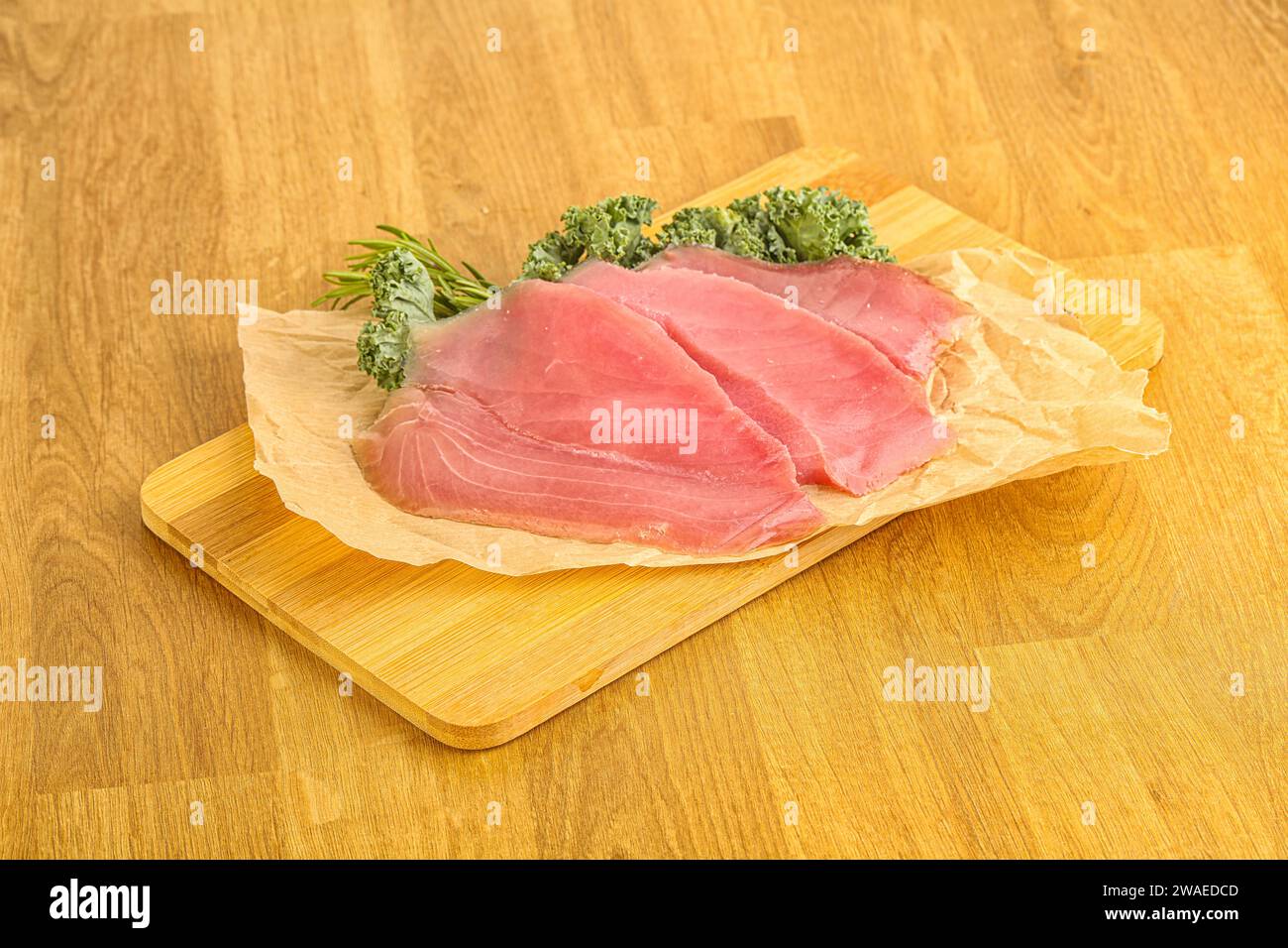 Raw salted tuna slice over board snack Stock Photo - Alamy