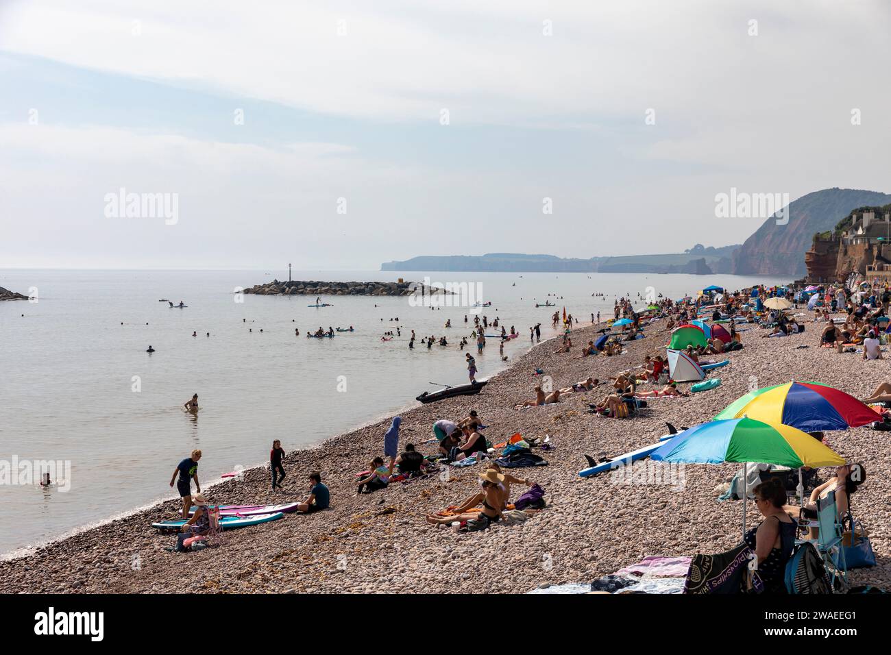Sidmouth Devon, people relax on the beach during hot September 2023 day ...