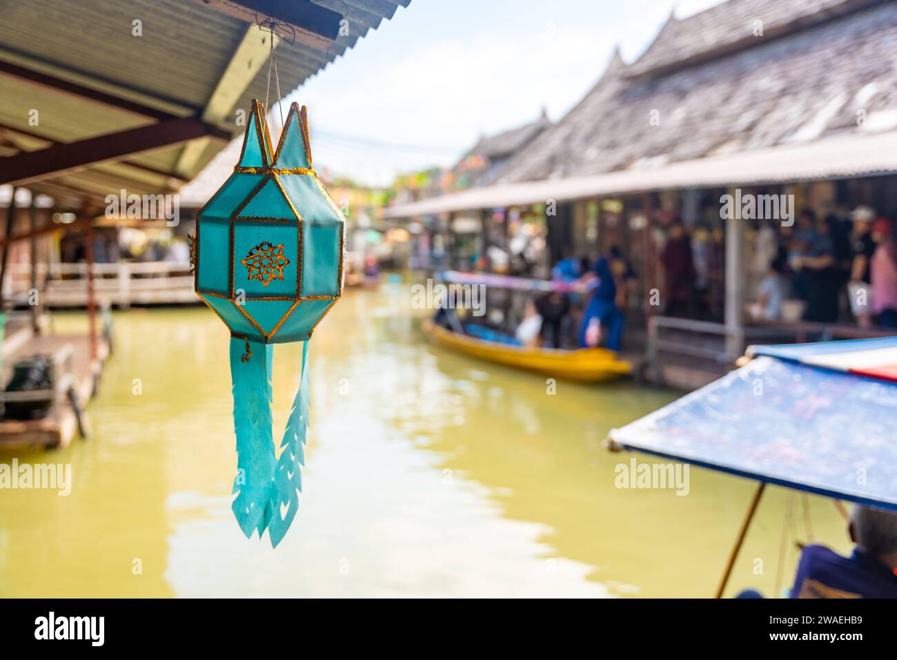 Green lantern in floating open air market with small houses - shops on the pond in Pattaya ...