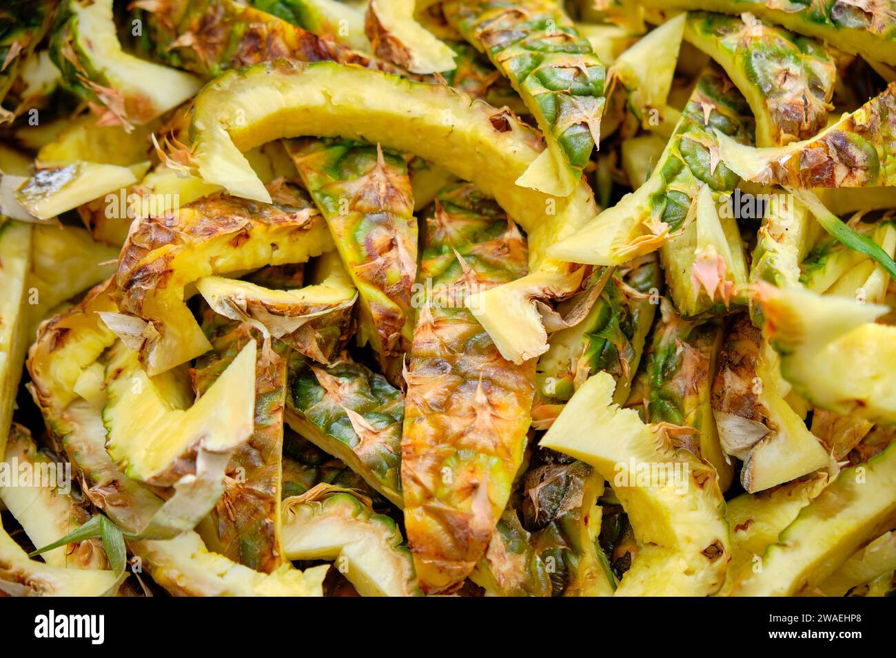 Cut out pineapple skin background. Pile of sliced rind with flesh ...