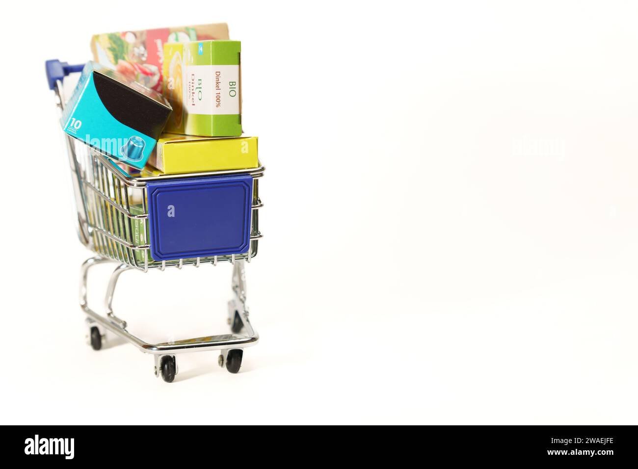 shopping cart full of boxes of grocery items isolated on a white ...