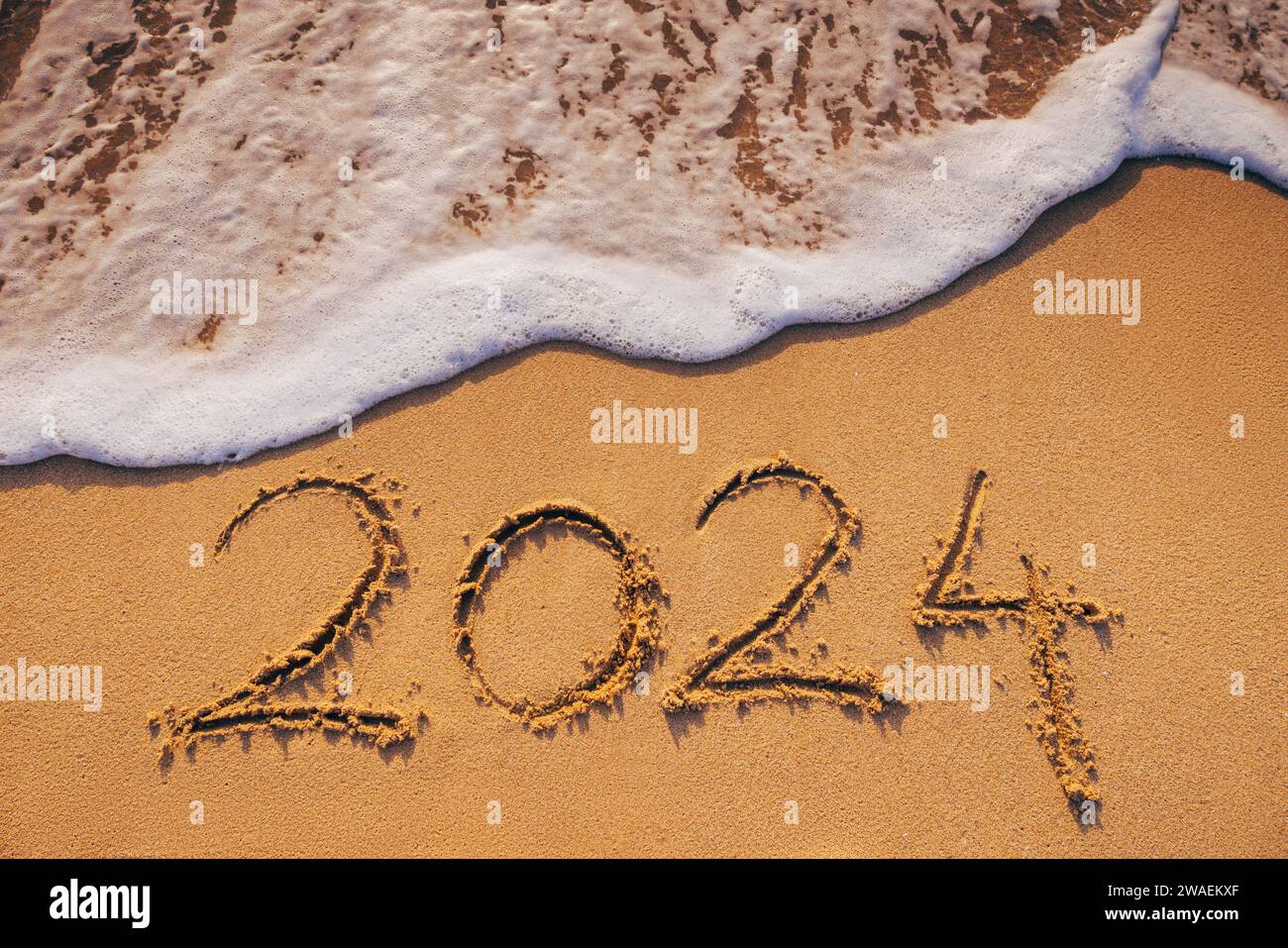 Happy New Year 2024 concept, lettering on the beach sand nature ...