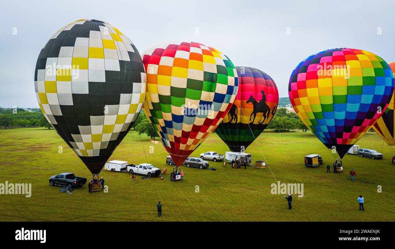 An aerial view of a colorful hot air balloons on a grassy field Stock ...