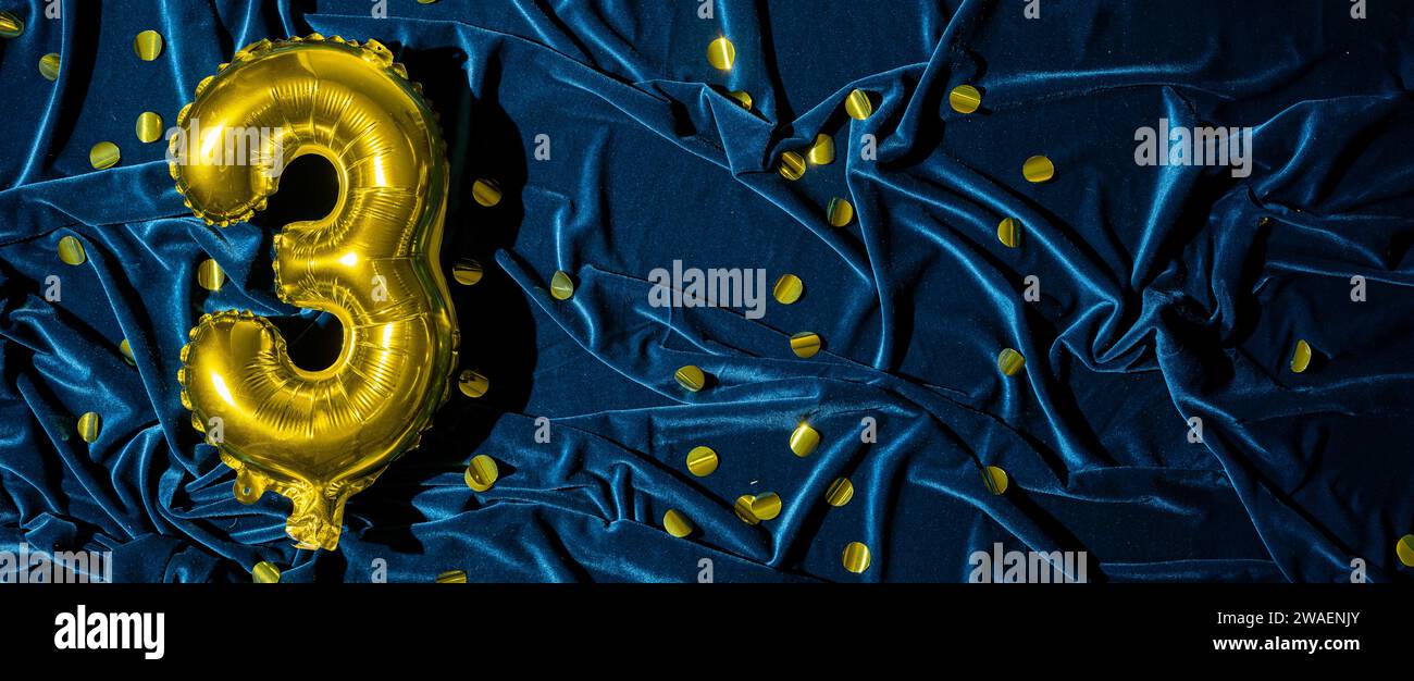 Gold foil balloon number three on blue velvet. Birthday greeting card with inscription 3. Golden ...