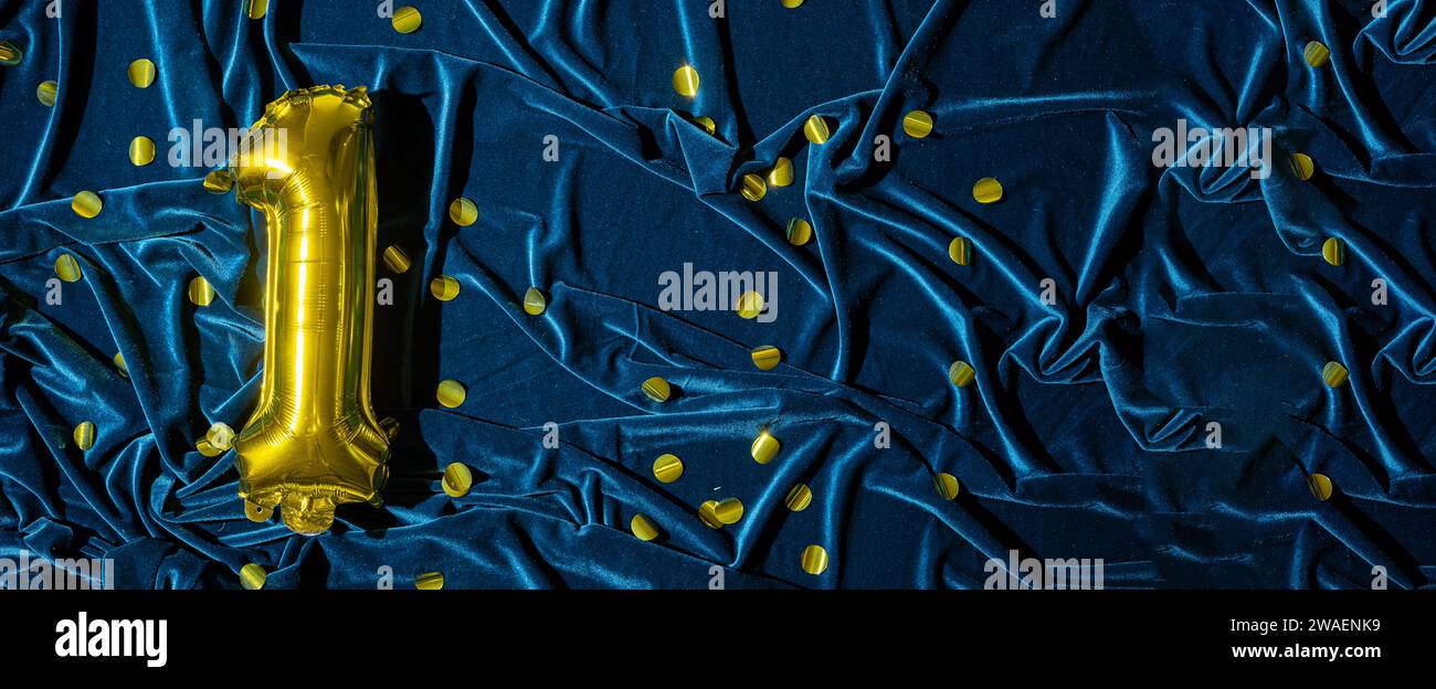 Gold foil balloon number one on blue velvet. Birthday greeting card with inscription 1. Golden ...