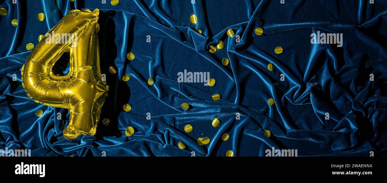 Gold foil balloon number four on blue velvet. Birthday greeting card with inscription 4. Golden ...