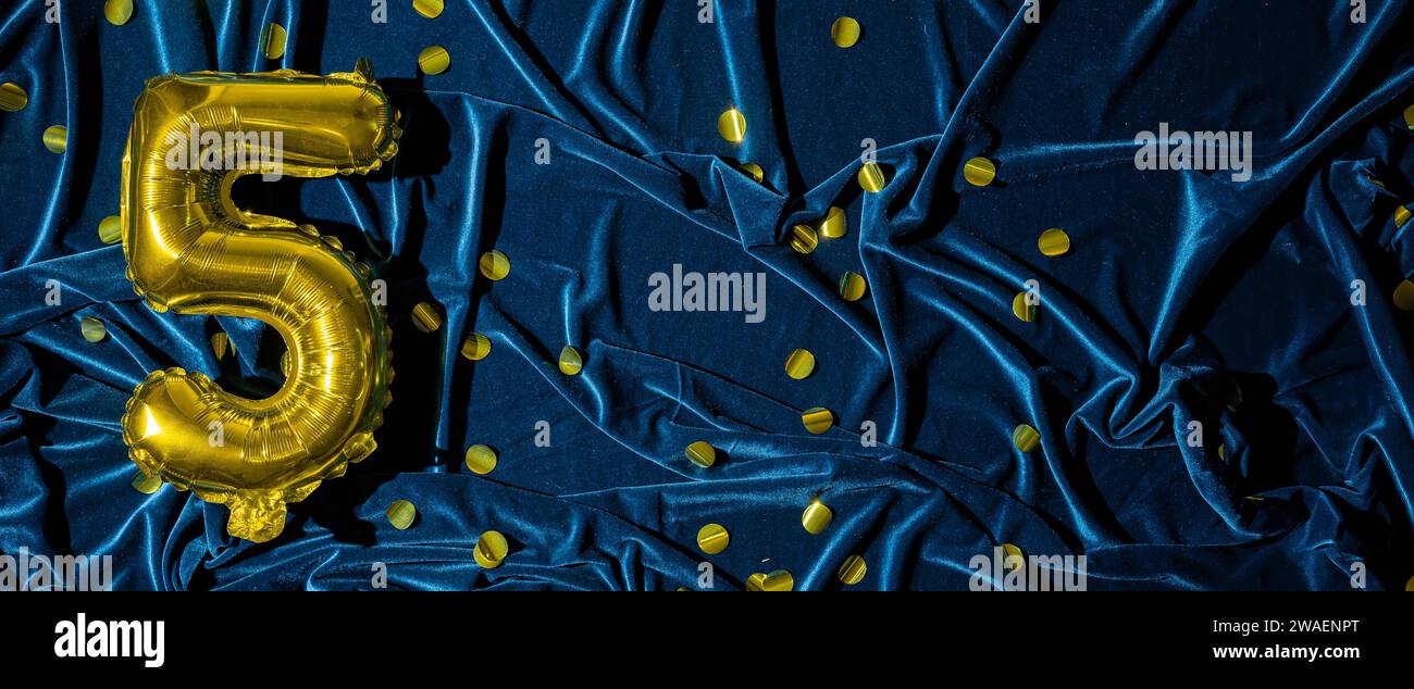 Gold foil balloon number five on blue velvet. Birthday greeting card with inscription 5. Golden ...