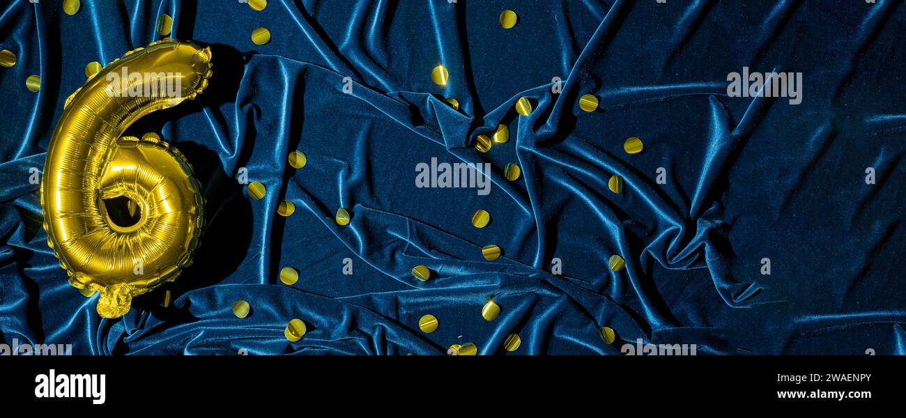 Gold foil balloon number six on blue velvet. Birthday greeting card with inscription 6. Golden ...