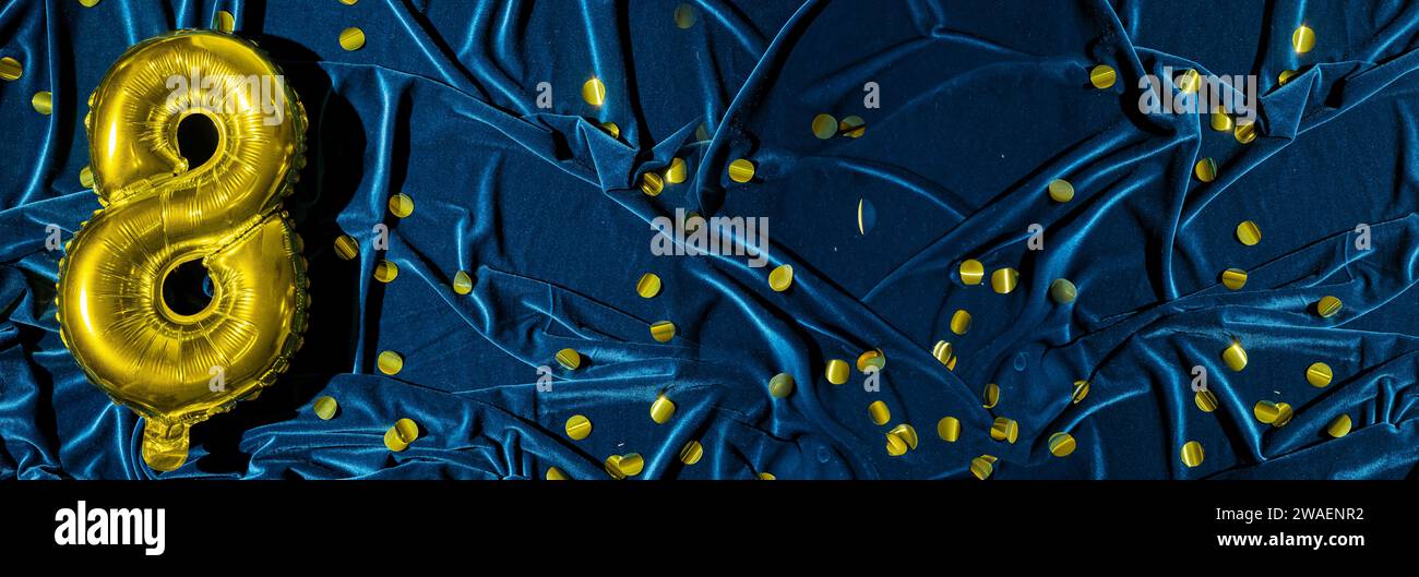 Gold foil balloon number eight on blue velvet. Birthday greeting card with inscription 8. Golden ...