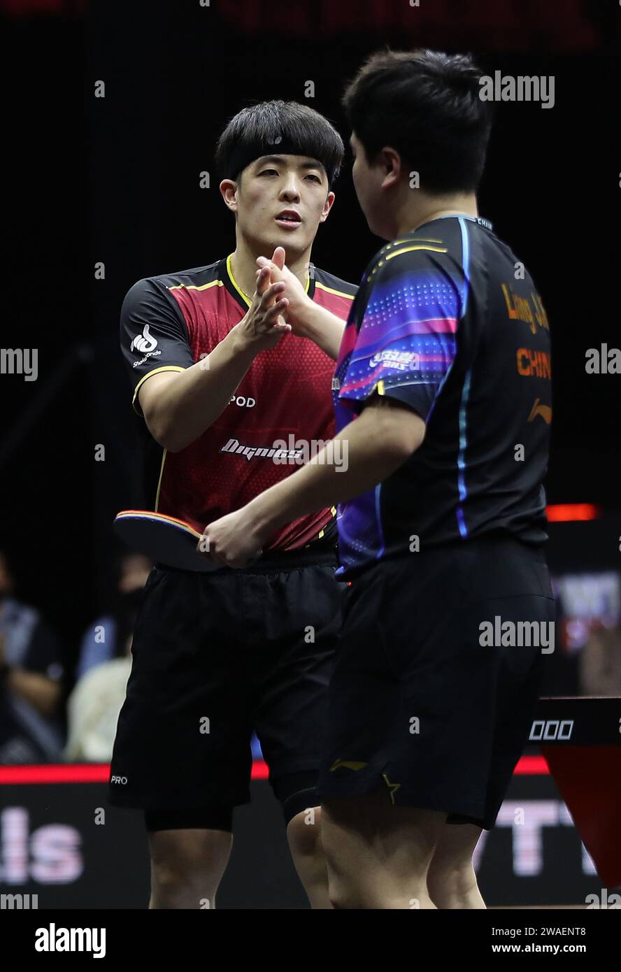 Doha, Qatar. 4th Jan, 2024. Qiu Dang (L) greets Liang Jingkun after the ...