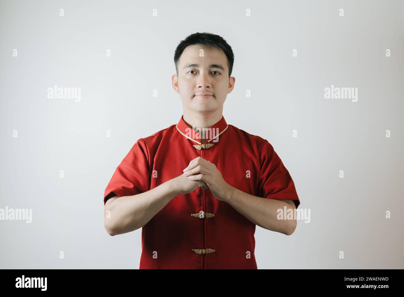 Gesture of congratulation of Asian man wearing Chinese traditional ...
