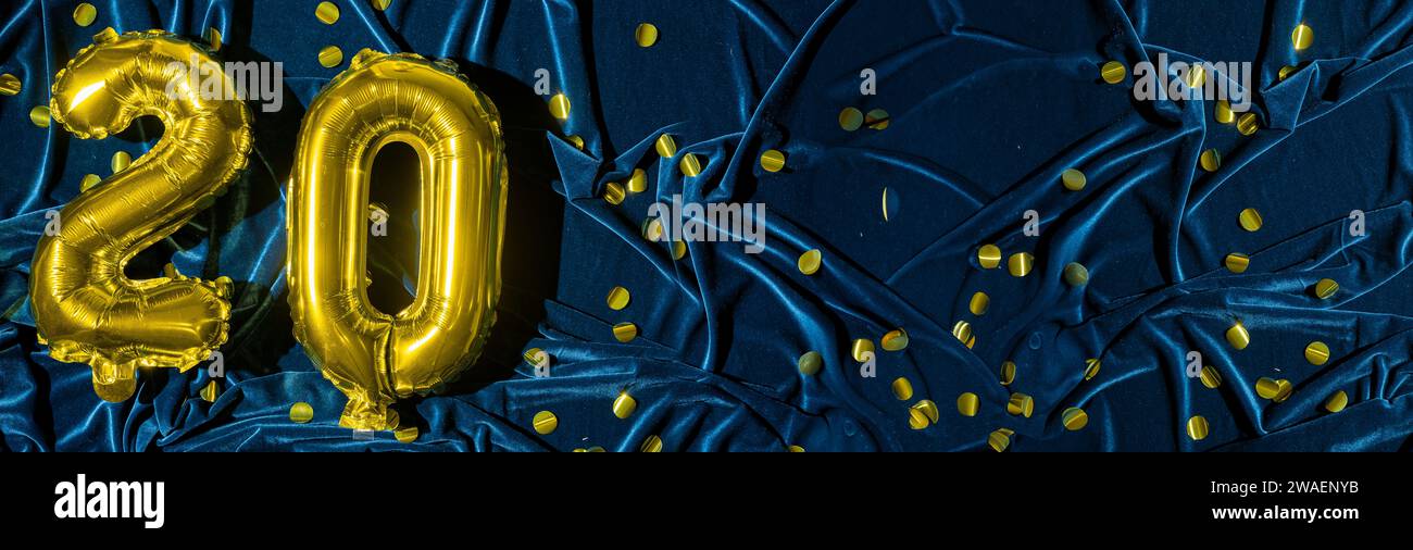 number twenty, gold foil balloon number on blue velvet background with ...